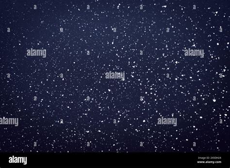 Natural snow particles in the air. Dark blue fading to black background. High quality photo ...