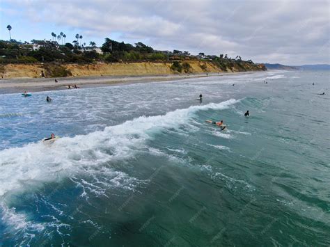 Premium Photo Aerial Top View Of Surfers Waiting The Waves In Blue