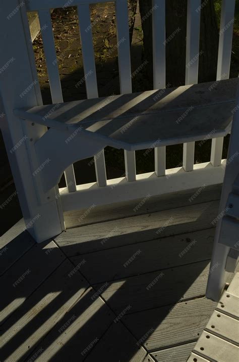 Premium Photo | White painted wood rails bench seat sunlight and shadow on wood porch floor of ...