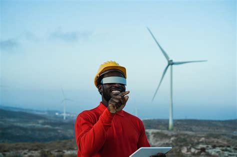 Premium Photo African Engineer Man Using Futuristic Augmented Reality Glasses On A Windmill