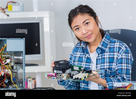 Woman Fixing A Computer At Work Stock Photo Alamy