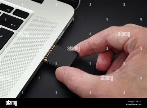 Inserting SD Card Into A Laptop Computer Closeup Stock Photo Alamy