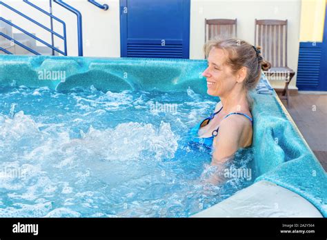 Middle Aged Caucasian Woman Bathing In Bath Tub With Bubbles Stock