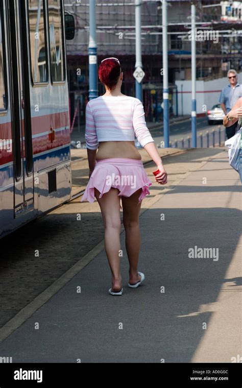Young Woman In Short Skirt Walking Over Bridge On Commercial Street