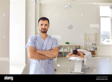 Serious Professional Masseur Or Manual Therapist Standing Arms Folded