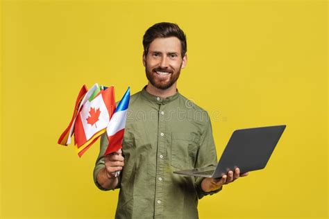Learn Foreign Languages Happy Man Holding Laptop And International Flags Middle Aged Male