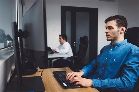 premium photo side view two programmers working in the office coding