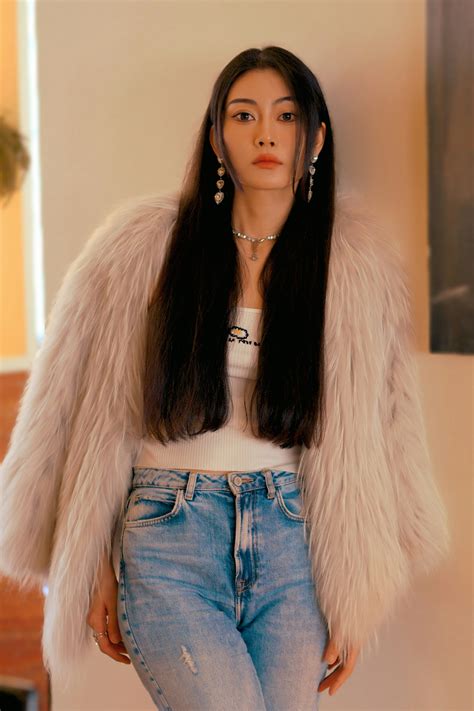 A Woman With Long Black Hair Wearing A Fur Coat Photo Free Pants
