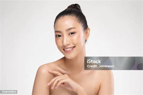 Beautiful Young Asian Woman Looking While Touching Shoulder Feeling So