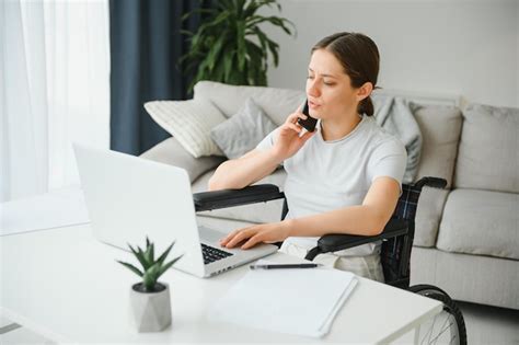 Premium Photo Female Freelance Programmer Sitting In Wheelchair And Using Computers While