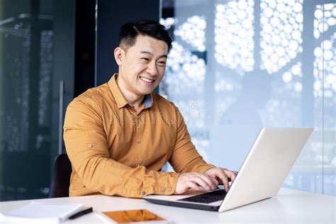 Successful Asian Programmer Developer Working With Laptop Inside Office Man In Shirt Smiling