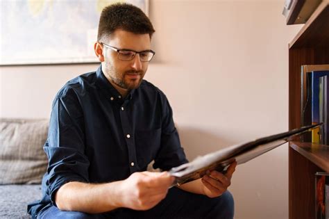 Premium Photo Serious Man Reading File At Home