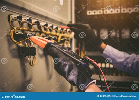 Close Up Hand Of Electrical Engineer Using Measuring Equipment To Checking Electric Current