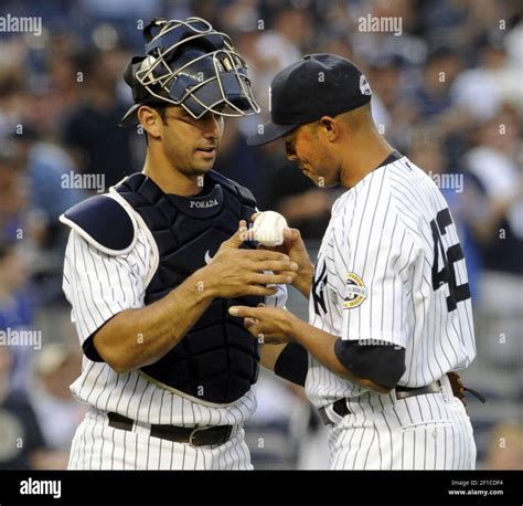 New York Yankees Catcher Jorge Posada Presents Relief Pitcher Mariano