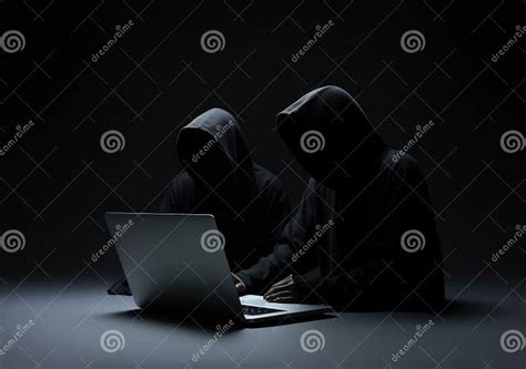 Hacker In Black Hoodie Working On Laptop In The Dark Room Dangerous Hooded Hacker Breaks Into