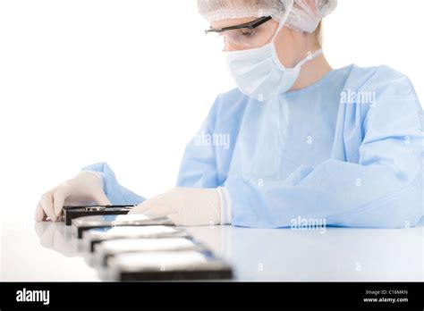 Female Computer Engineer Repair Hard Disc Defect Experiment In Sterile Laboratory Stock Photo
