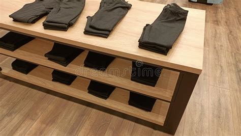 This Is A Neatly Organized Display Of Pants Within A Retail Store