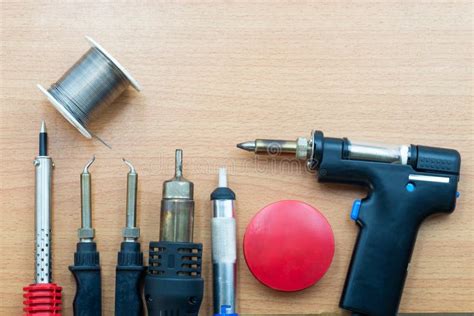Essential Electronics Soldering And Desoldering Tools Arranged On A