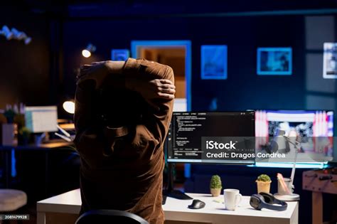 Programmer Doing Software Quality Assurance Stretching Arms Behind Back