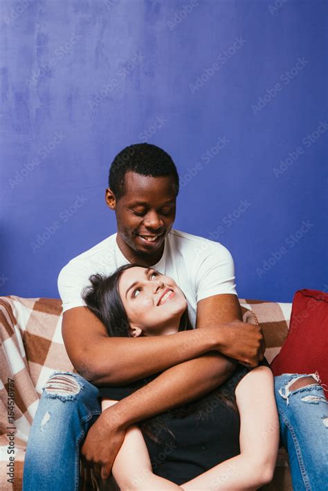 Young Happy Couple In Love Black Man And White Woman Cuddle And Caress