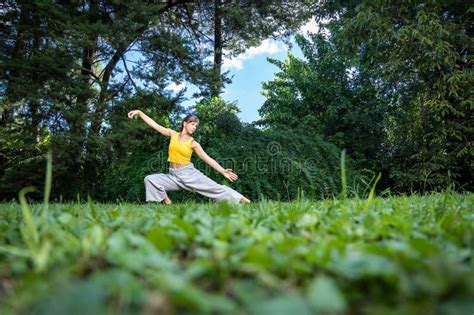 Woman Practising Qi Gong Tai Chi Angle At Ground Level Selective