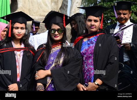 A Group Of Graduates Expressing Their Delight In Front Of The Sculpture