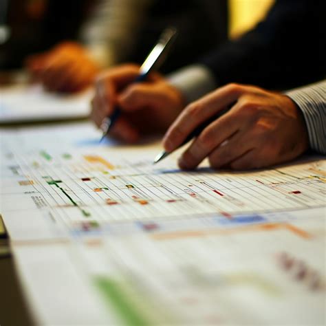 A Project Manager Monitoring Resource Usage And Adjusting Allocations