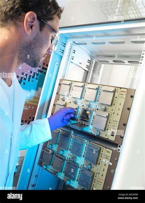 Alpha Spectroscopy Scientist Loading A Sample That Has Been Dried Onto A Metal Disc Into An
