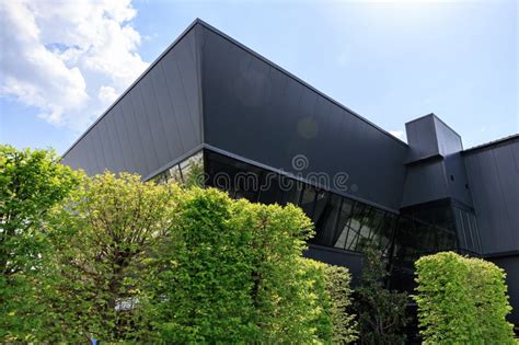 Modern Angular Architecture With Lush Greenery On A Sunny Day Stock