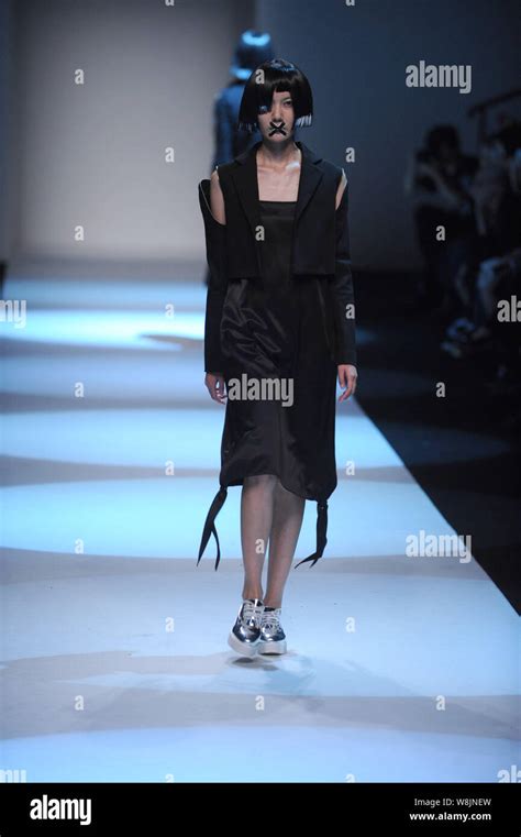 a model displays a new creation at the zhang yuhao fashion show during