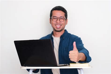 Premium Photo Adult Asian Man Smiling And Give Thumb Up While Working