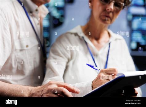 Aged Colleagues Monitoring Server Rows Optimizing Them For Data Processing Requirements Of Ai