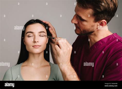 Blepharoplasty Surgeon Is Checking Distance In Between Dotted Lines On