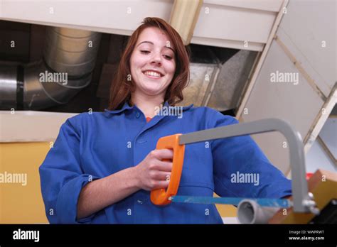 Woman Using A Hacksaw Stock Photo Alamy