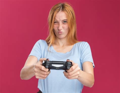 Free Photo Unpleased Young Redhead Ginger Girl With Freckles Holding