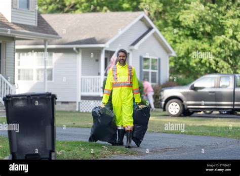 Pollution and recycling. Man putting garbage bag in a trash bin. Environmental protection ...
