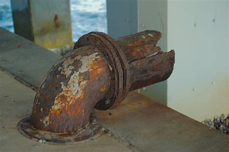 낮 동안 콘크리트 슬래브의 물 근처에 있는 크고 녹슨 오래된 파이프 0명에 대한 스톡 사진 및 기타 이미지 0명 강철 관로 Istock