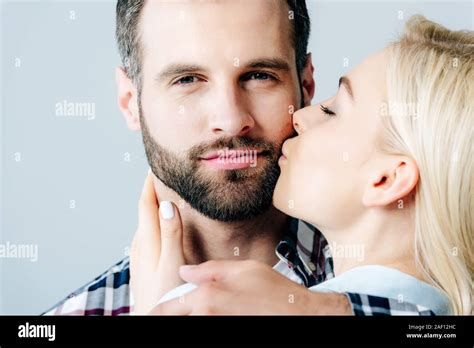 Beautiful Blonde Girl Kissing Handsome Man Isolated On Grey Stock Photo Alamy