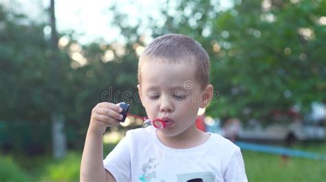 Close Up Portrait Of A Boy Blowing Soap Bubbles Stock Video Video Of