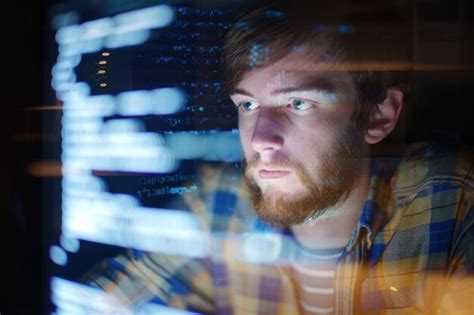 Premium Photo Focused Male Programmer Working On Computer Code At Night