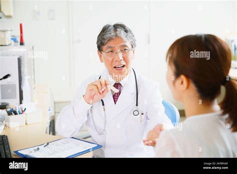 Japanese Woman Being Examined By A Doctor Stock Photo Alamy