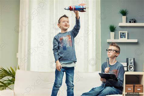 ولدان يلعبان معاً في المنزل بصاروخ الألعاب واللوح صورة الأسهم 4356309 Crushpixel