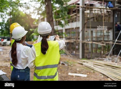Structural Engineer And Architect Discussing And Working With