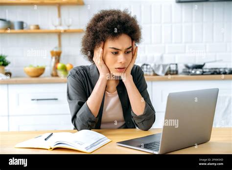Upset Tired African American Curly Young Woman Student Programmer Or Freelancer Sit In A