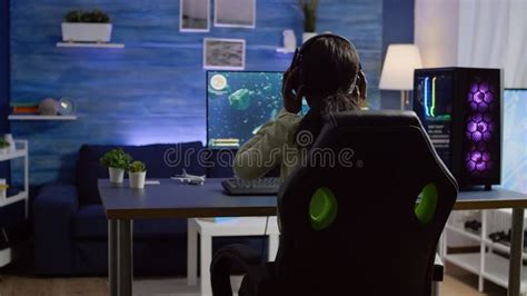 Gaming At Home Gamer Wearing Headphones And Playing Online Video Game