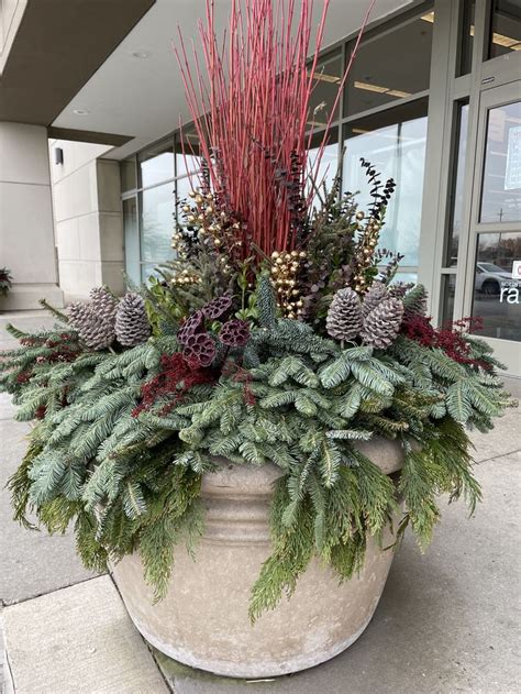 Festive Holiday Planter With Pine Cones And Evergreens