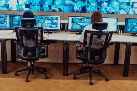 Group Of Security Data Center Operators Working In A Cctv Monitoring
