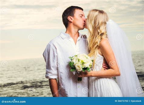 Bride And Groom Romantic Newly Married Couple Kissing At The Be Stock