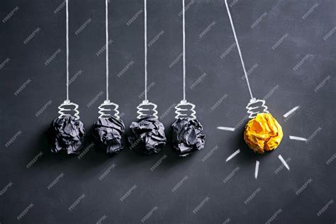 Premium Photo Crumpled Paper Pendulum On Blackboard Idea Concept