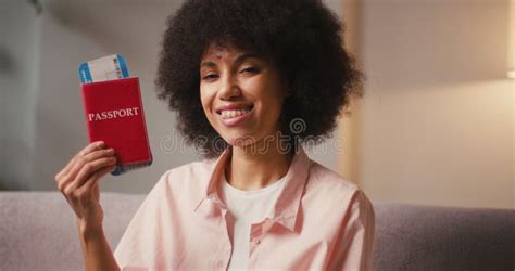 Smiling Woman Shows Passport With Tickets Sitting On Sofa Stock Video